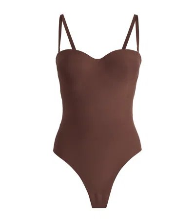 Skims Moulded Underwire Thong Bodysuit In Brown | ModeSens